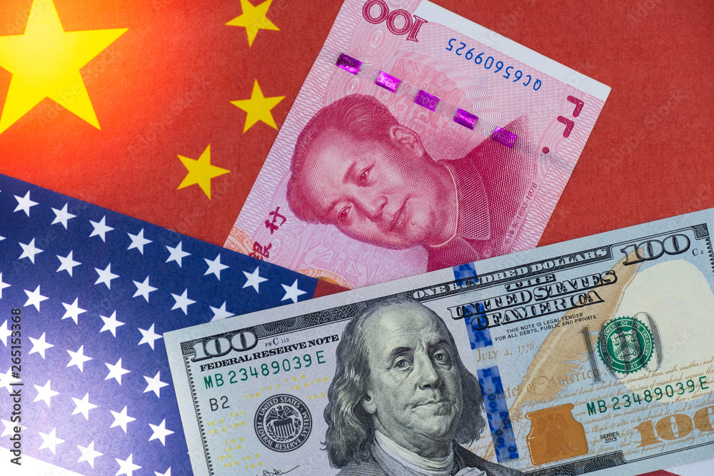 US dollar and Yuan banknote on USA and China flags. Its is symbol for ...