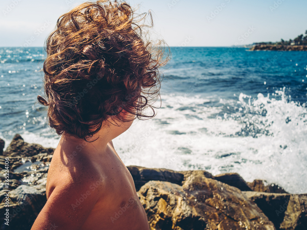 Side view of shirtless girl looking at sea Stock Photo | Adobe Stock