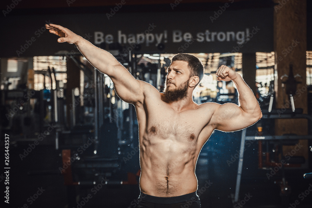 Foto de Stock Good looking young man bodybuilder posing in front of the ...