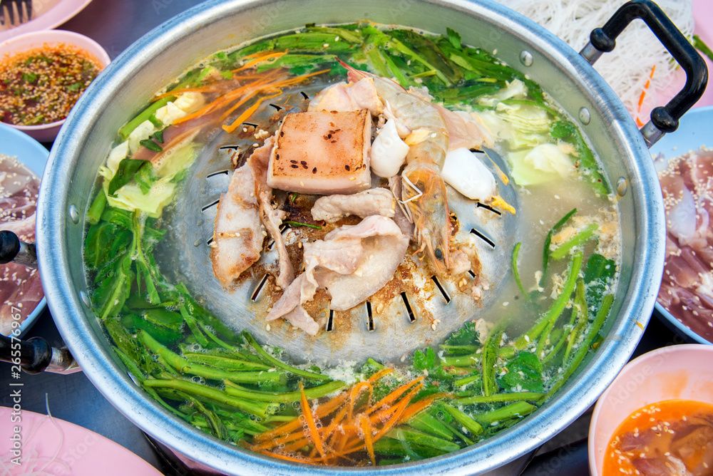 Stock-Foto „Hot barbecue Grill Pork on hot pan buffet, It's traditional ...