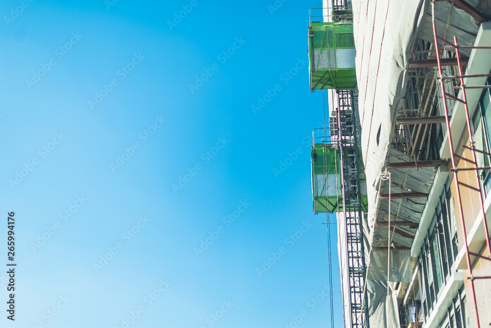 Construction site background. Hoisting cranes and new multi-storey ...
