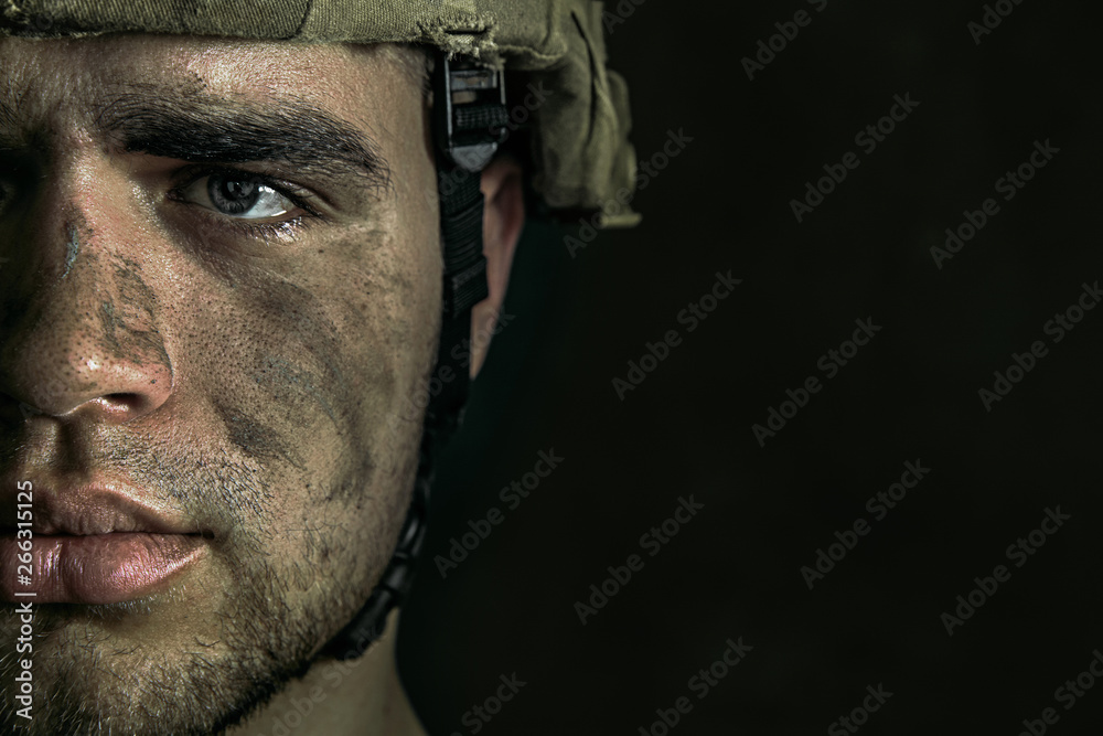 Confusing what is real. Close up portrait of young male soldier. Man in ...