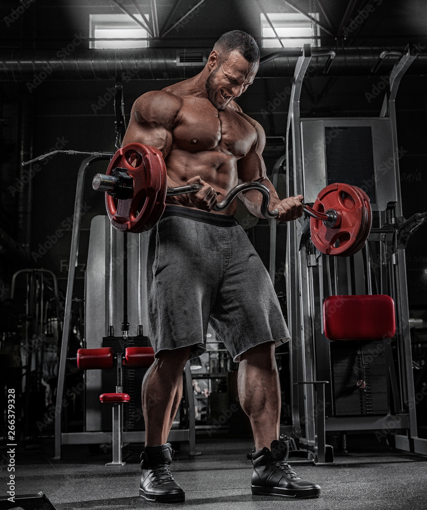 Brutal strong athletic men pumping up muscles and train in gym workout bodybuilding on diet ...