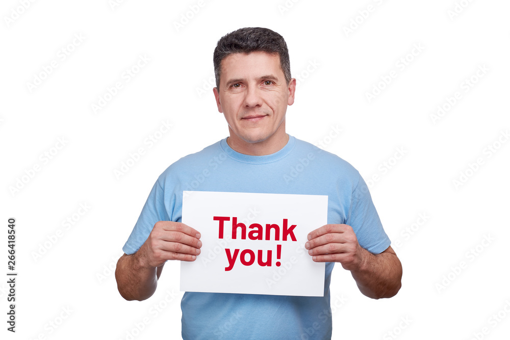 middle aged man holds paper sheet with text thank you in two hands and ...