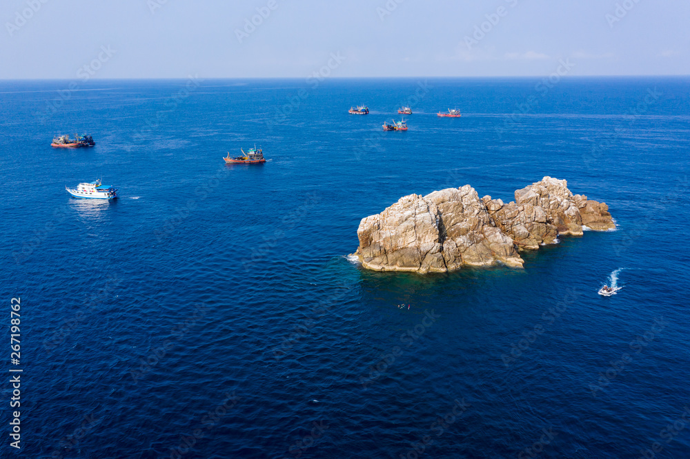 Industrial overfishing - Aerial view of a SCUBA diving boat and a fleet ...