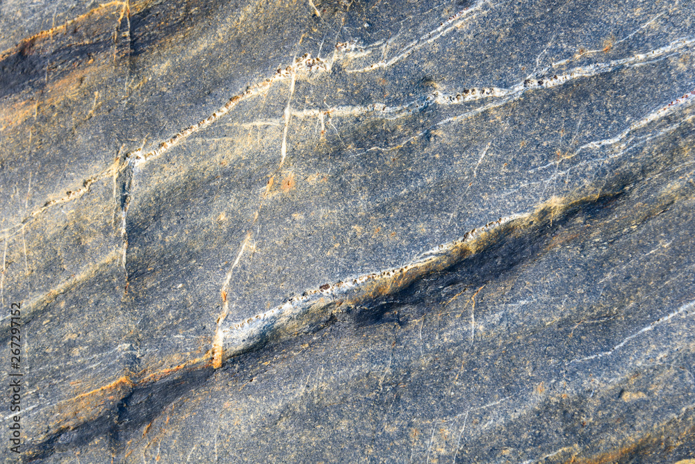 Blue gray stone with white and orange diagonal lines of pattern and ...