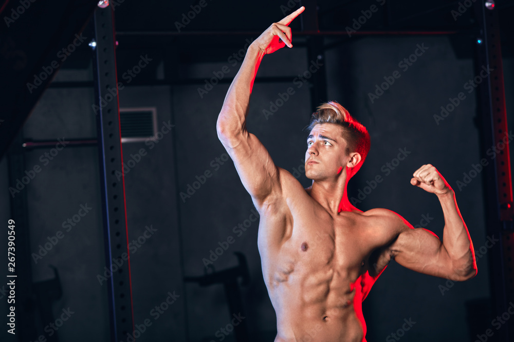 Muscular european bodybuilder posing on stage. Handsome Fitness man ...