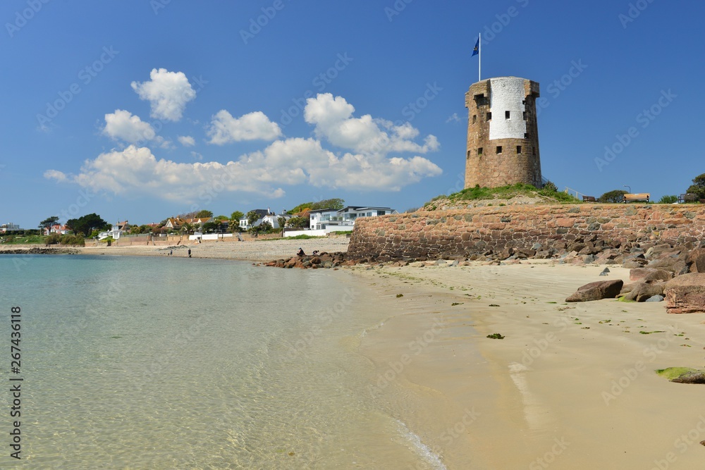 Le Hocq, Jersey, U.K. Spring high tide on the beach with a 19th century ...