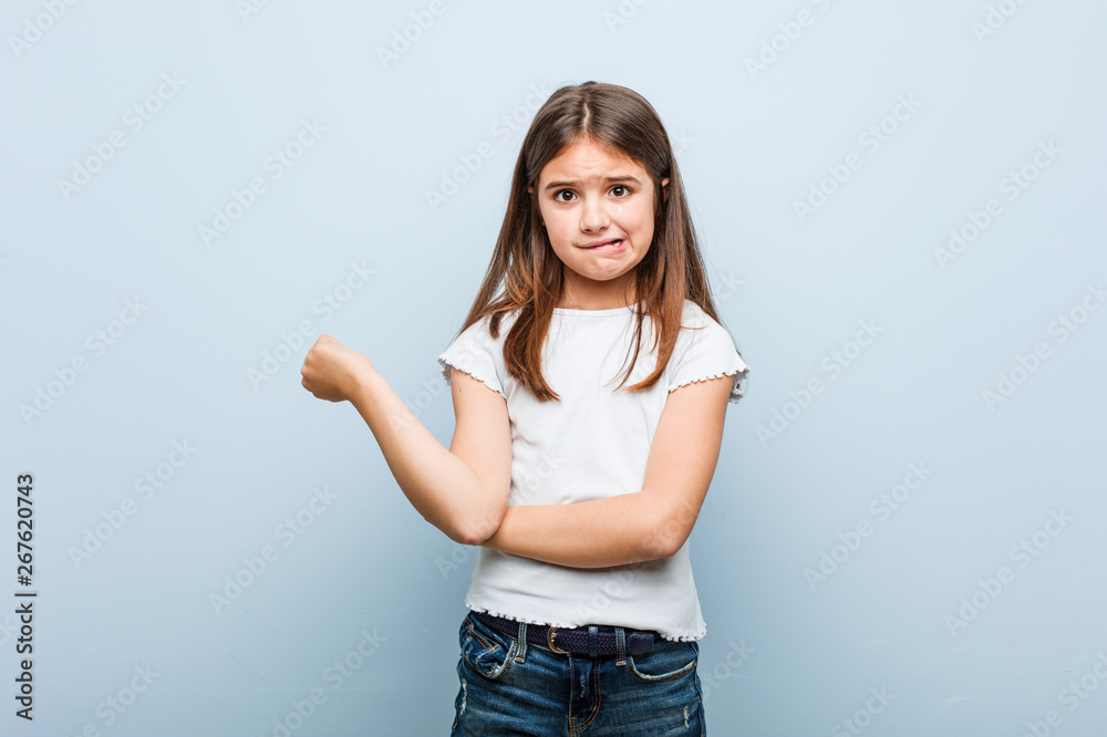 Cute girl touching back of head, thinking and making a choice. Stock ...