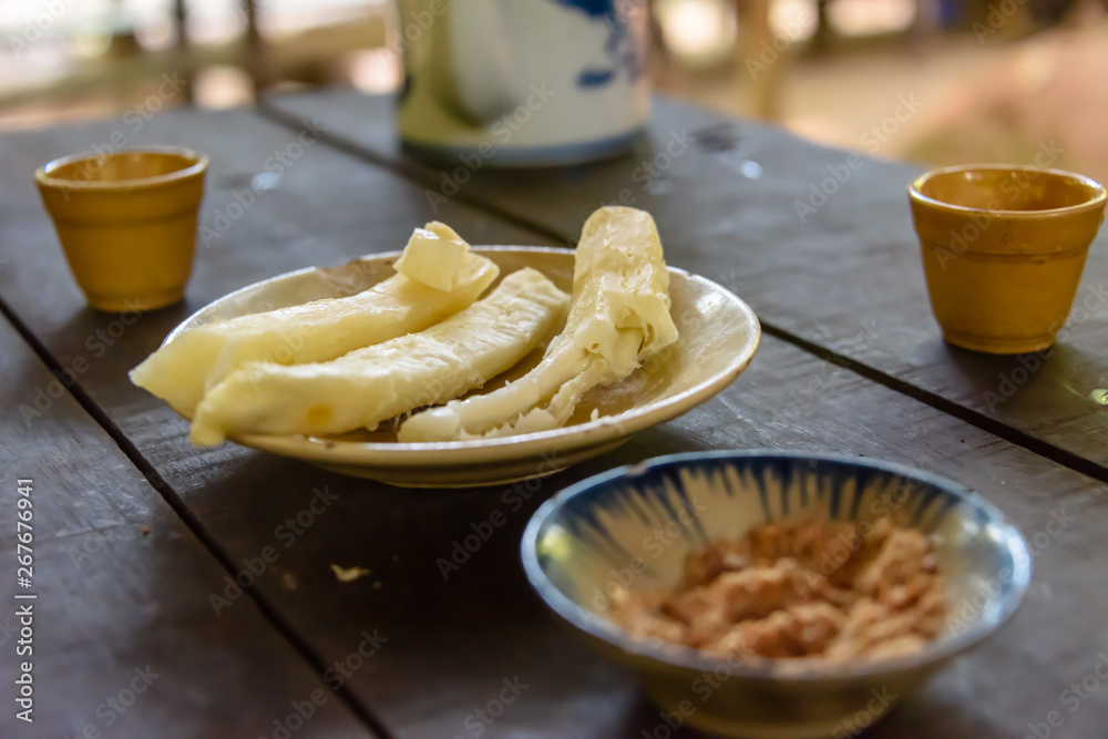 Plate of tapioca root which is dipped into a mix of salt, pepper and ...