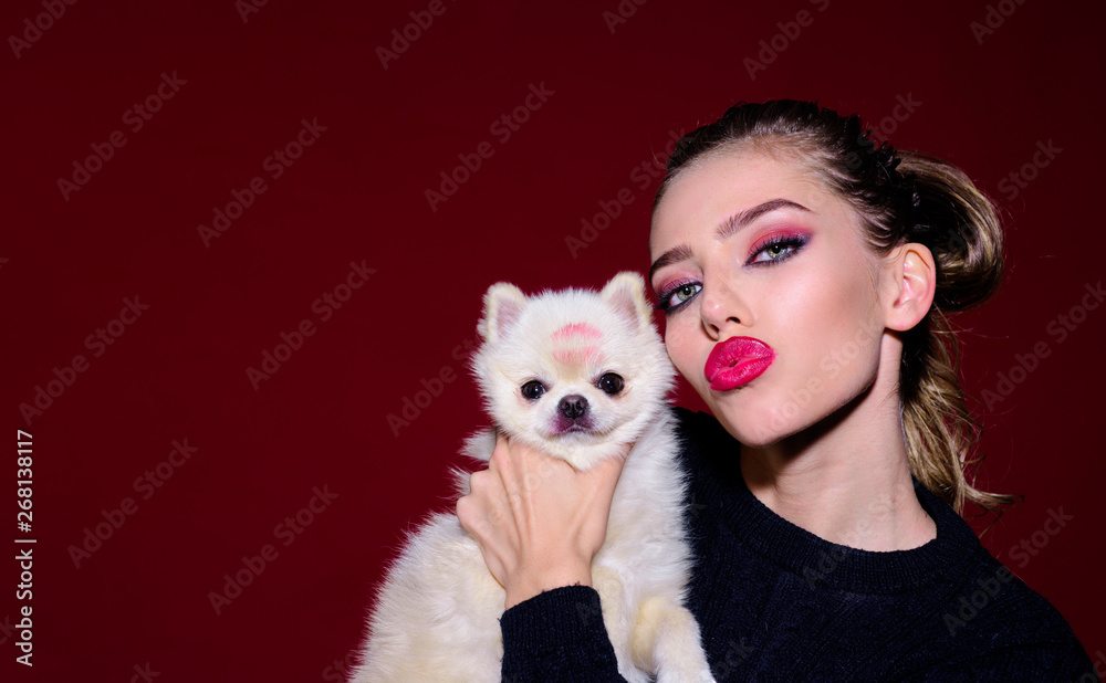 Woman in black sweater embracing pomeranian spitz dog. Sensual woman ...