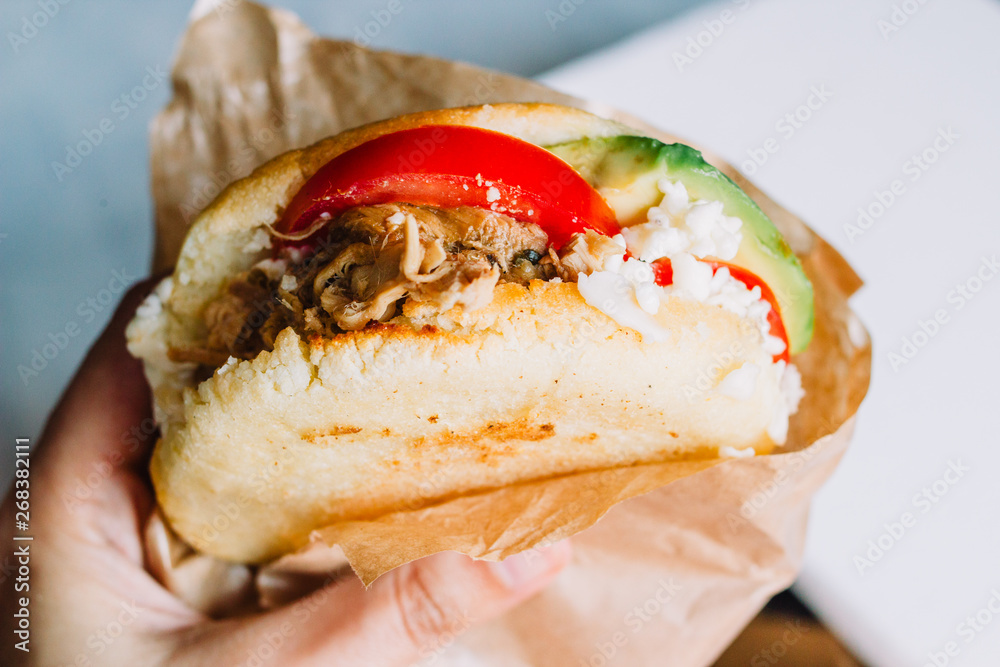 Arepa venezolana is a traditional dish from Venezuela filled with meat ...