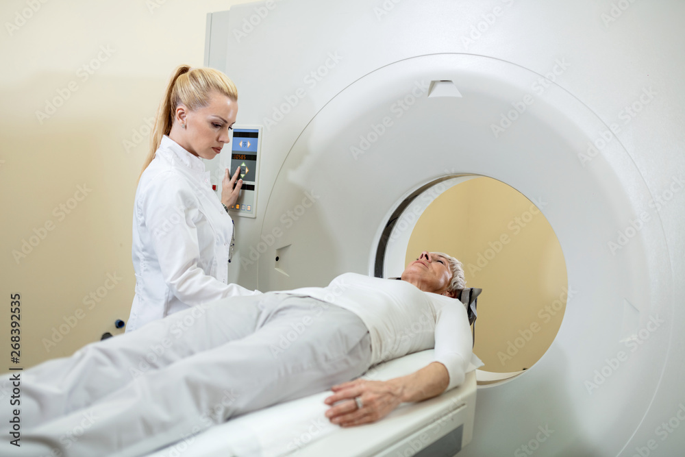 Radiologist ad mature patient during CT scan procedure. Stock Photo ...