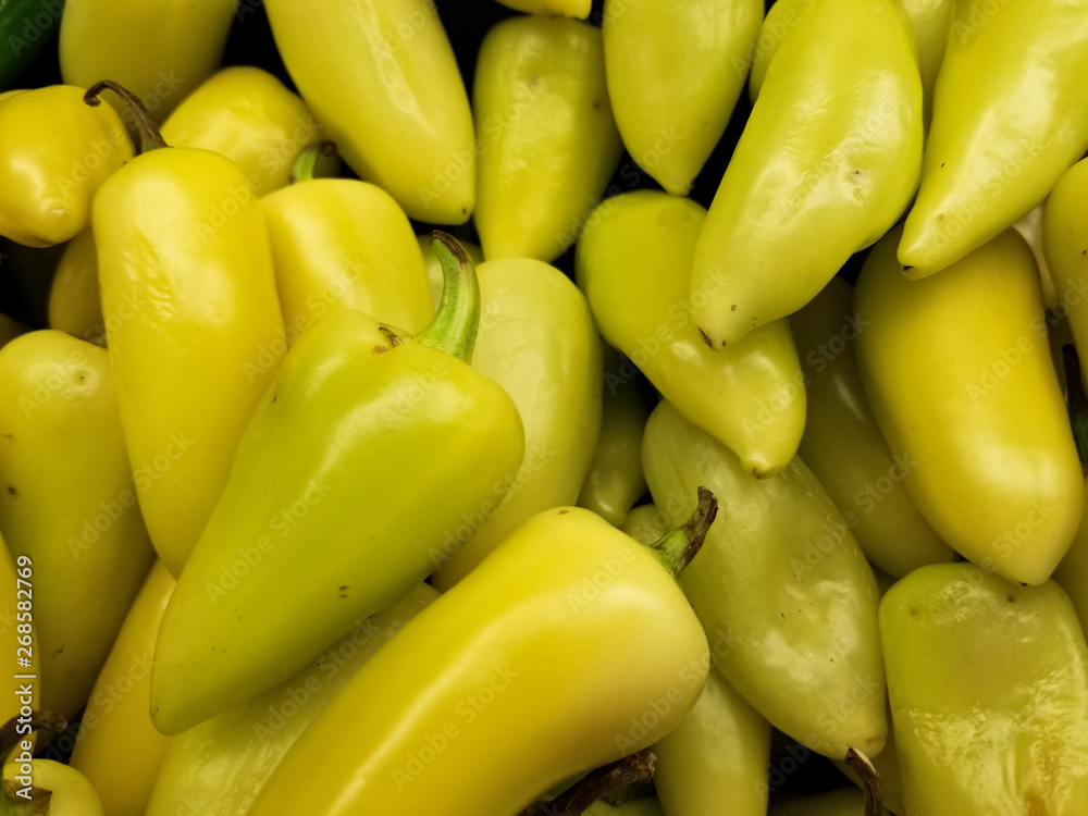Hot yellow Caribe chili peppers in a supermarket shelf. Also named ...