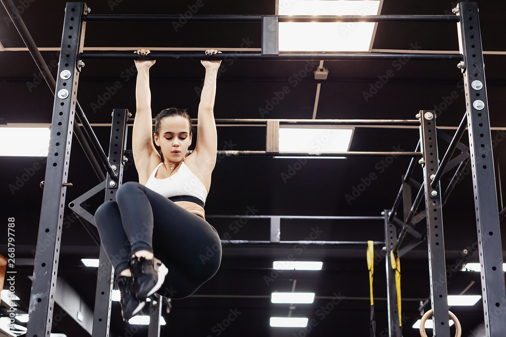 Bottom view - a strong athletic young champion girl works with her own ...