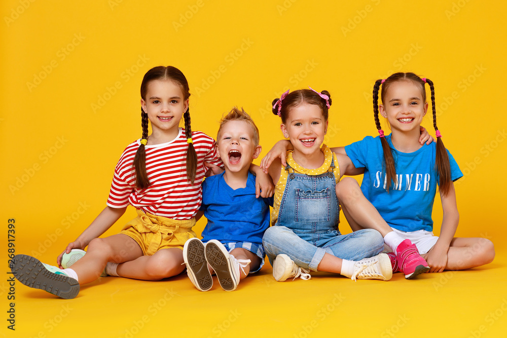 group of cheerful happy children on colored yellow background. Stock ...