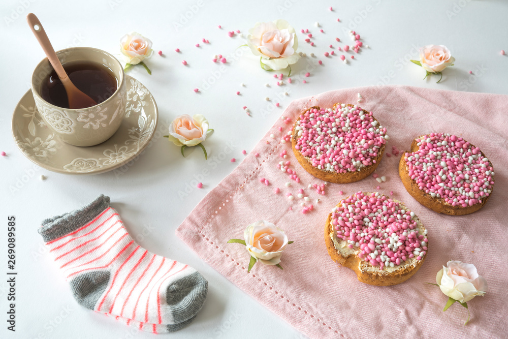 cup of tea with crispy rusk with traditional Dutch food pink muisjes ...