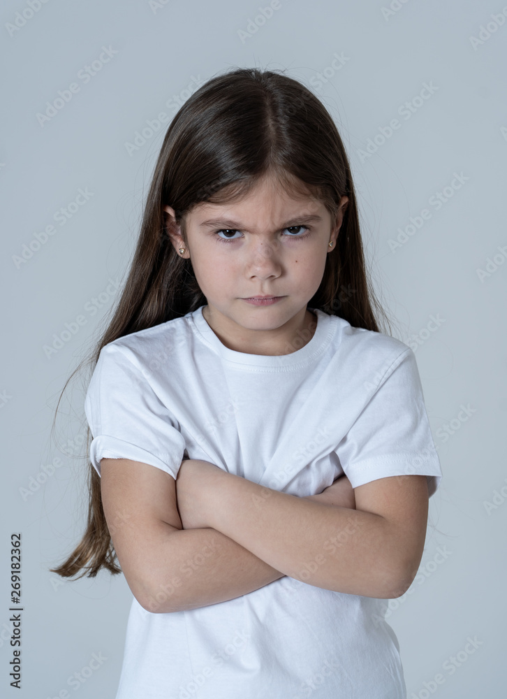 Pretty little girl with a angry facial expression looking mad at the ...