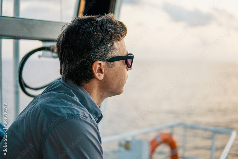 Marine navigational officer or chief mate on navigation watch on ship ...