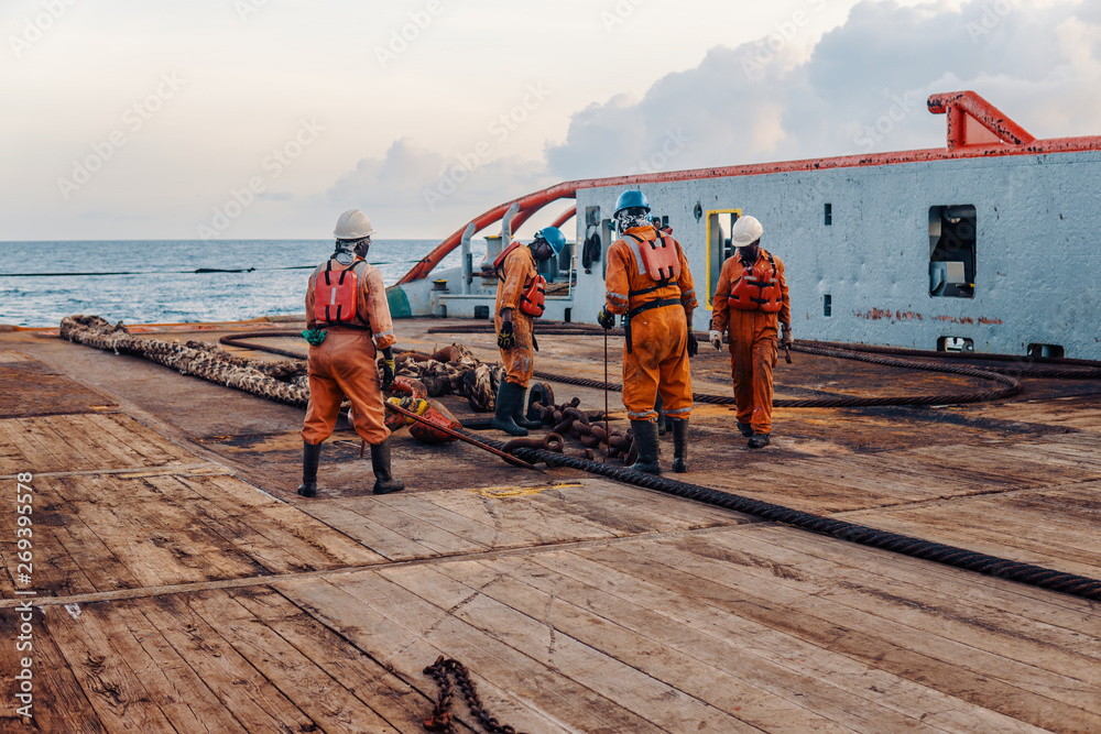 Anchor-handling Tug Supply AHTS vessel crew preparing vessel for static ...