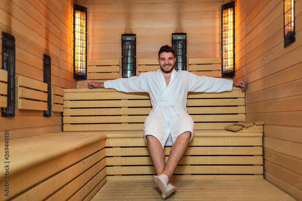 Handsome man relaxing in sauna and staying healthy Stock Photo | Adobe ...