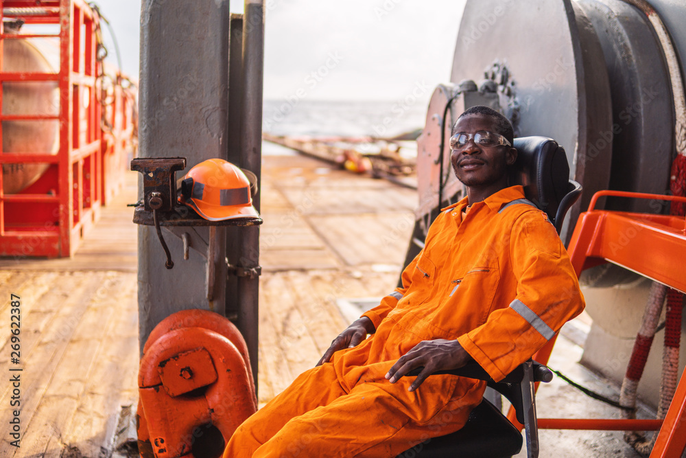 happy Seaman AB or Bosun on deck of vessel or ship , wearing PPE ...