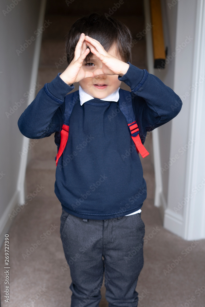 Schoolboy making triangle sign, Cute little boy looking at camera ...