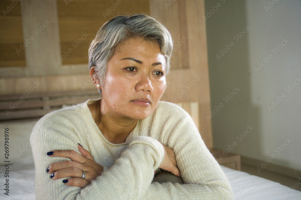 depressed and sad grey hair mature woman crying lonely sitting on bed ...
