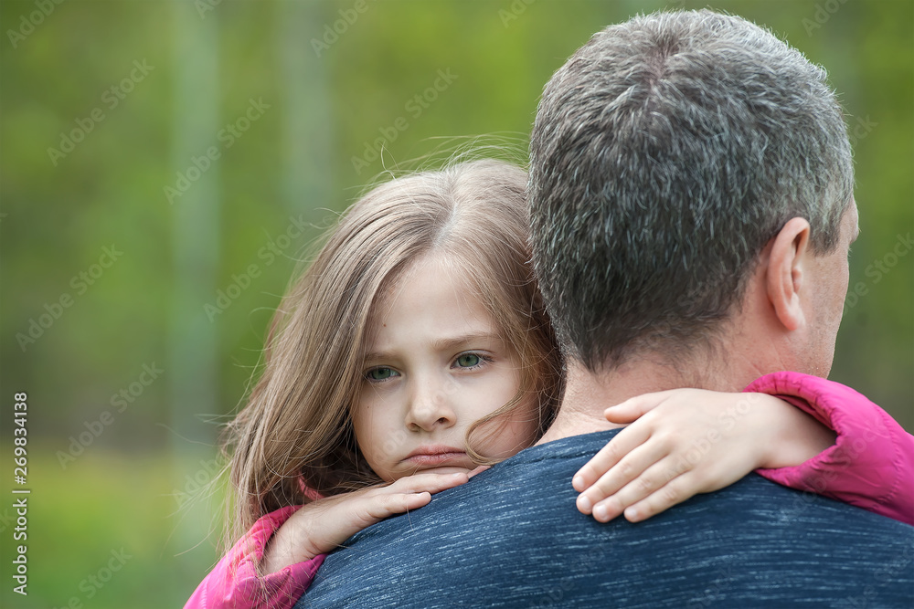 Portrait of one sad daughter hugging her father Stock Photo | Adobe Stock
