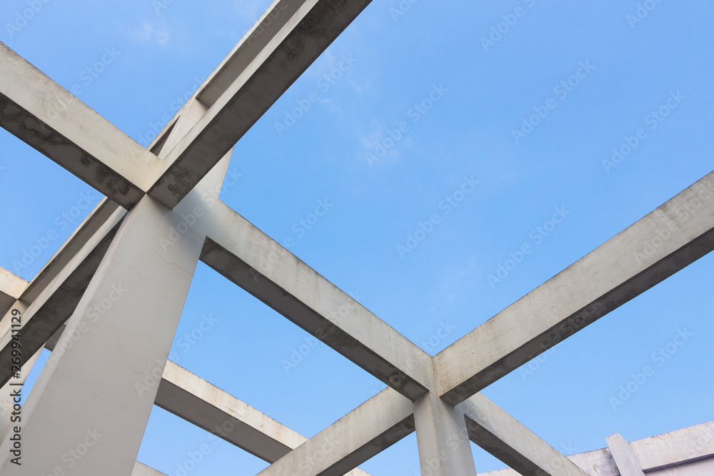 Looking up at the concrete pillars and beams at the top of modern high ...