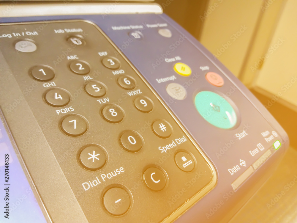 Hand press button on panel of printer, Finger pressing the start button on a multifunction ...