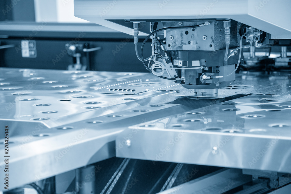 Turret punching machine cutting the metal plate. Metal forming machine ...