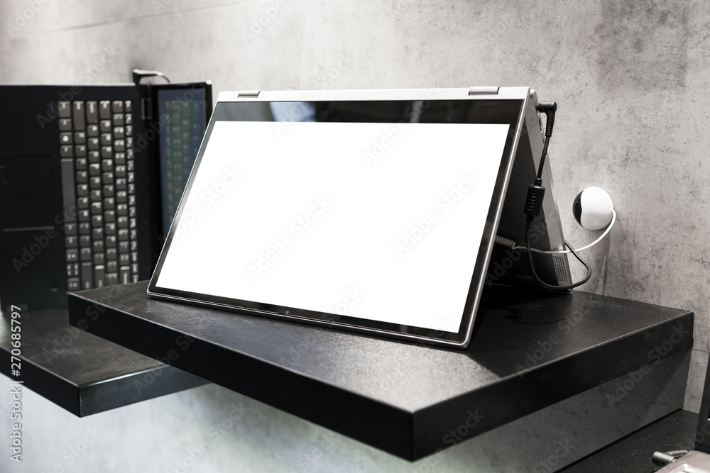 Modern laptop transformer on the store shelf. White screen mock up for ...