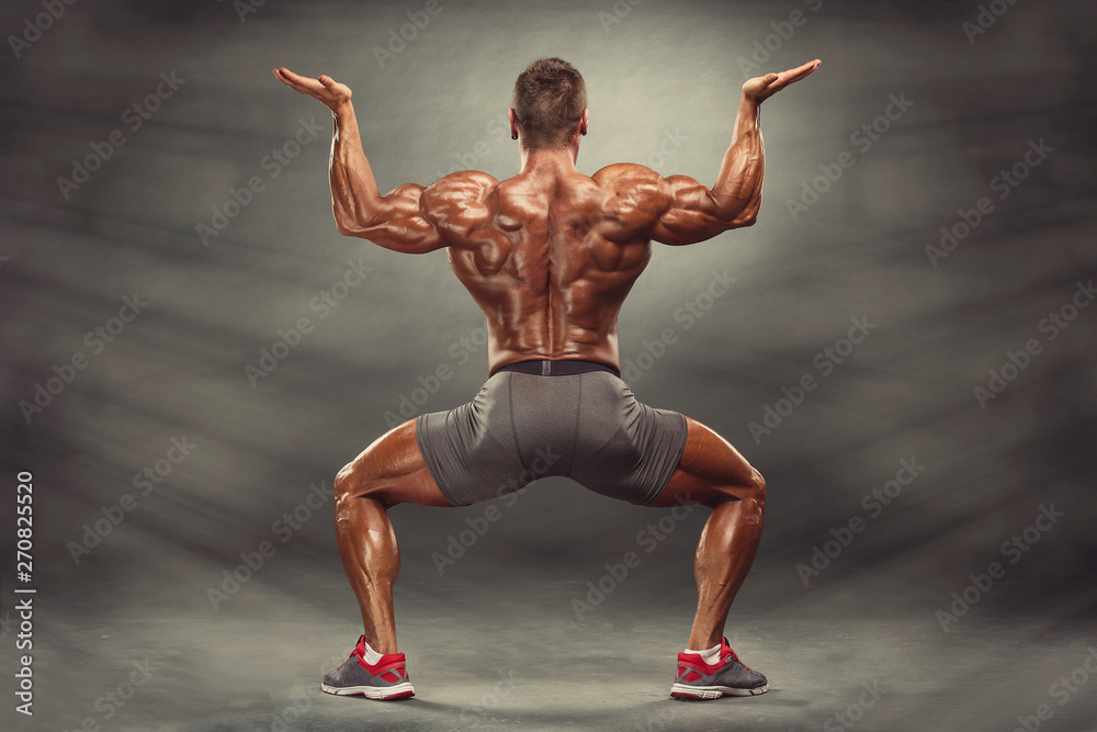 Strong Muscular Men Flexing Muscles from the Back. He is showing back ...