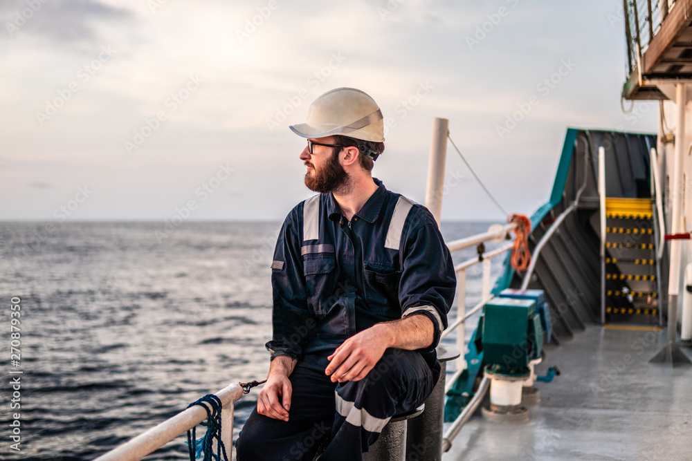 Deck Officer on deck of offshore vessel or ship , wearing PPE personal ...
