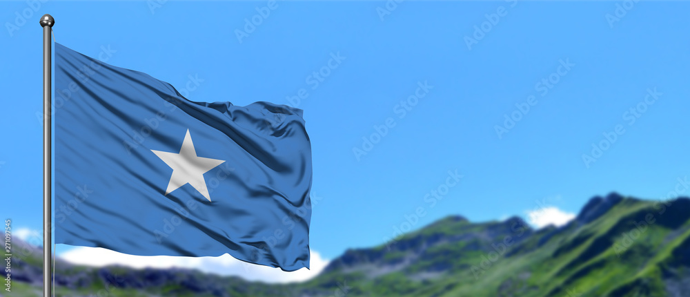 Somalia flag waving in the blue sky with green fields at mountain peak ...