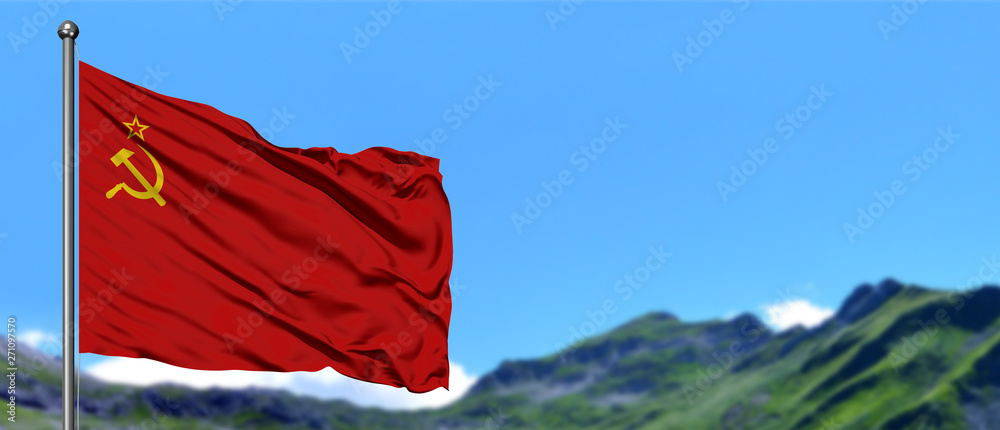 Soviet Union flag waving in the blue sky with green fields at mountain ...