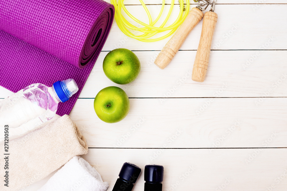 Set of Yoga practice with purple mat, dumbbell, towel, bottle of water ...