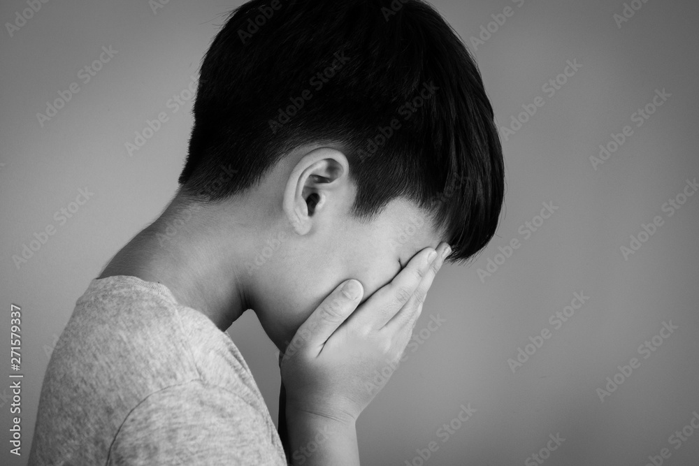 Worried, depressed, sad tween / preteen Asian boy (12 -15 years old ...