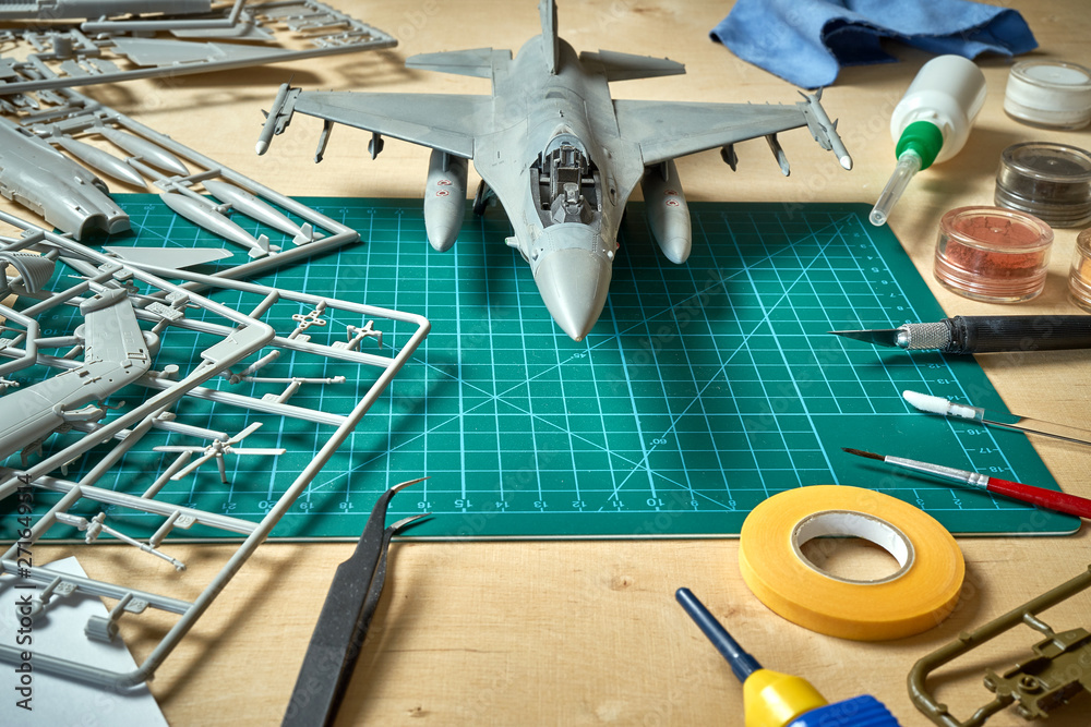 Top view on plastic model scale with accessories on green pad on wooden ...