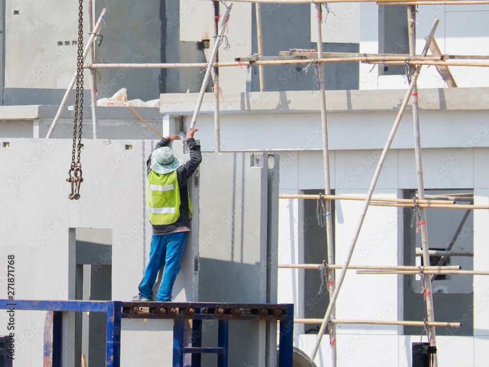Construction worker are installing the precast concrete wall, worker ...