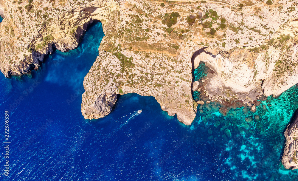 Blue Grotto in Malta. Pleasure boat with tourists runs. Natural arch ...