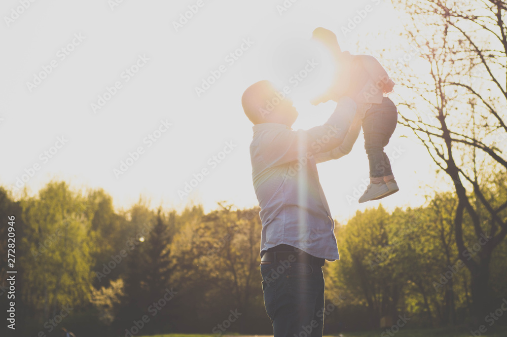 Happy family together, parents with their little child at sunset ...