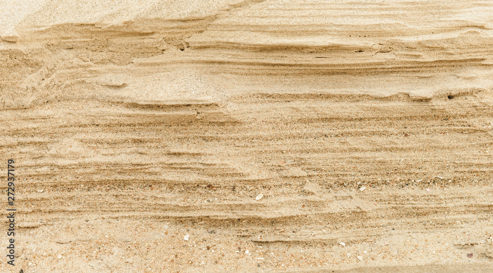 Layers of sand on the beach, soft sandstone at the shore. Abstract ...