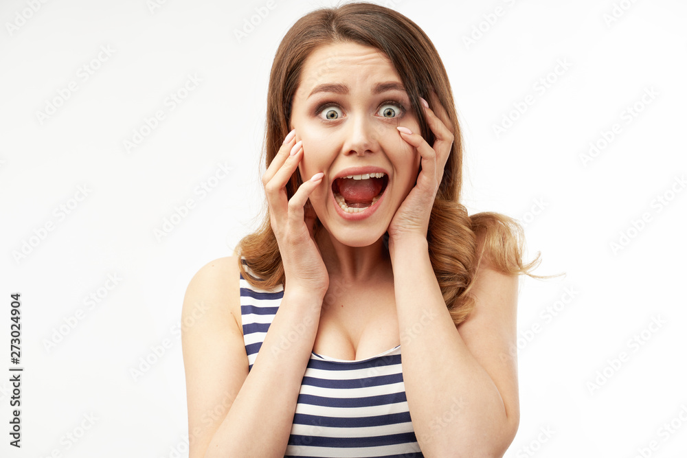 Portrait of impressed female with stunned expression, keeps hand on ...