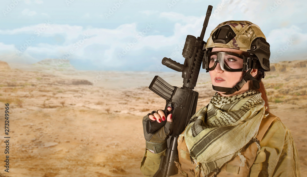Fully equipped military soldier woman with red lacquer nails holding an ...