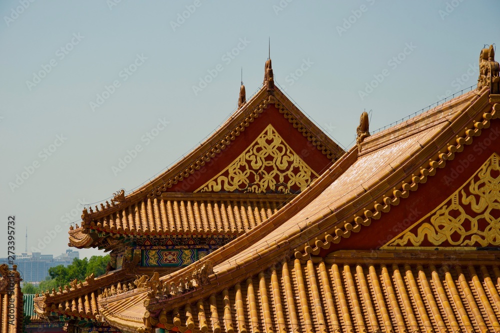 Ornate gold and red paintwork on roofs of traditional Chinese buildings ...