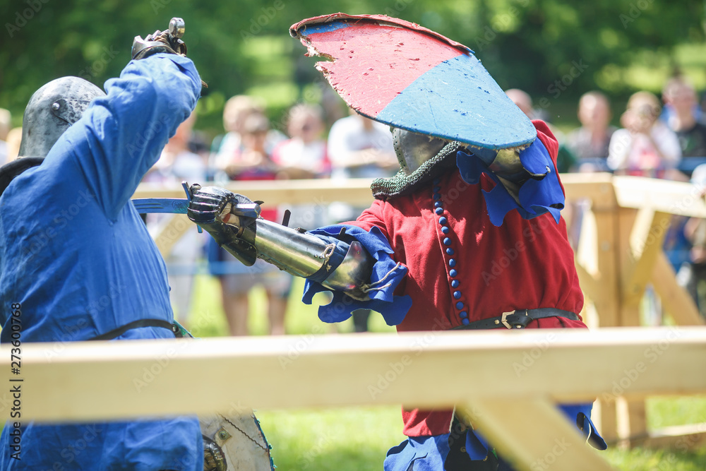 medieval jousting knight fight, in armor, helmets, chain mail with axes ...