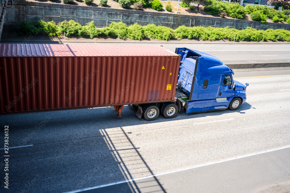 Blue comfort long haul big rig semi truck with long container driving ...