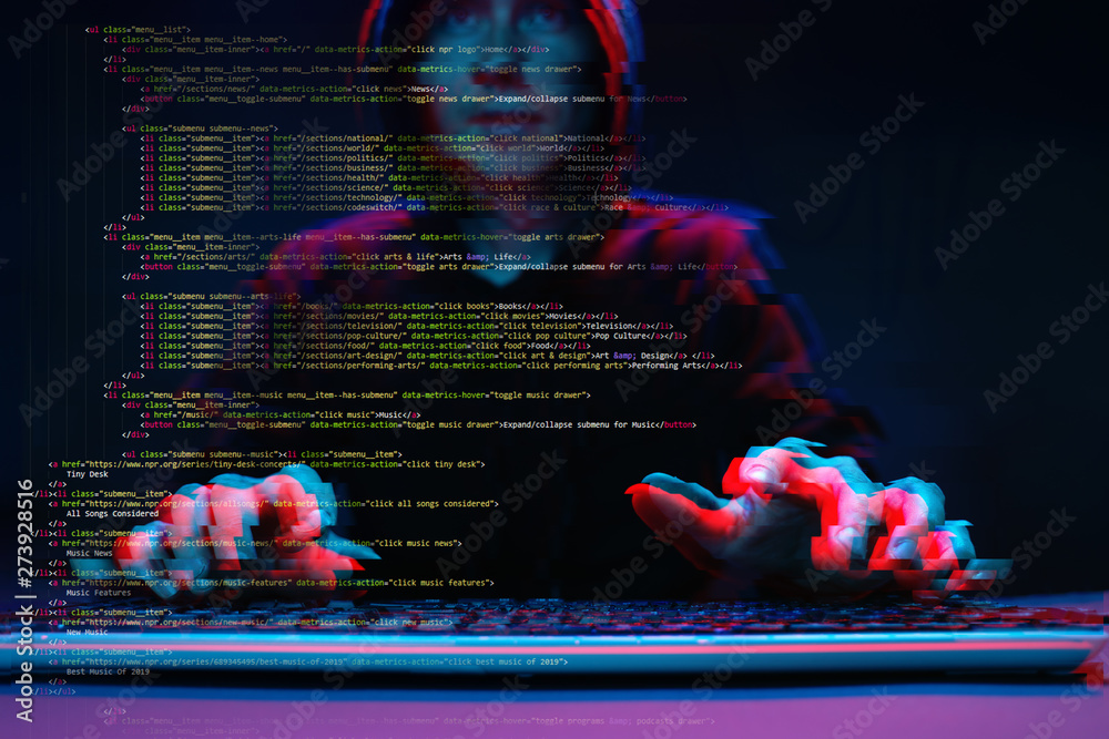 Hacker working with computer in dark room with digital interface around ...